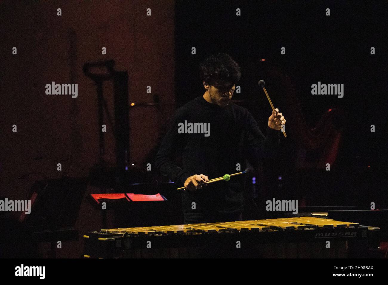 A young male playing percussion on stage Stock Photo - Alamy