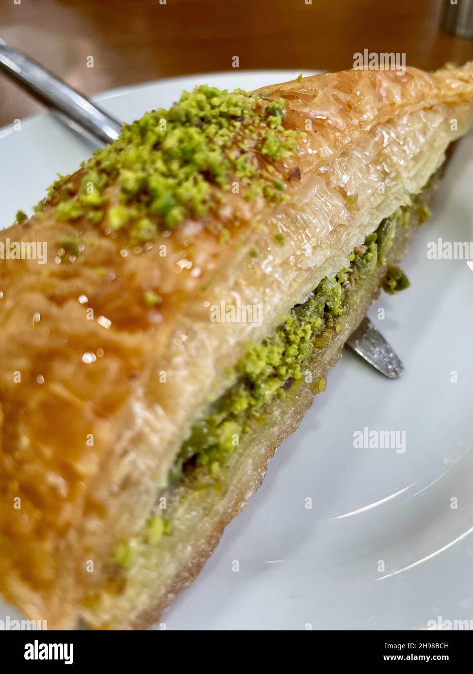 A vertical closeup shot of delicious baklava dessert on a plate Stock Photo - Alamy