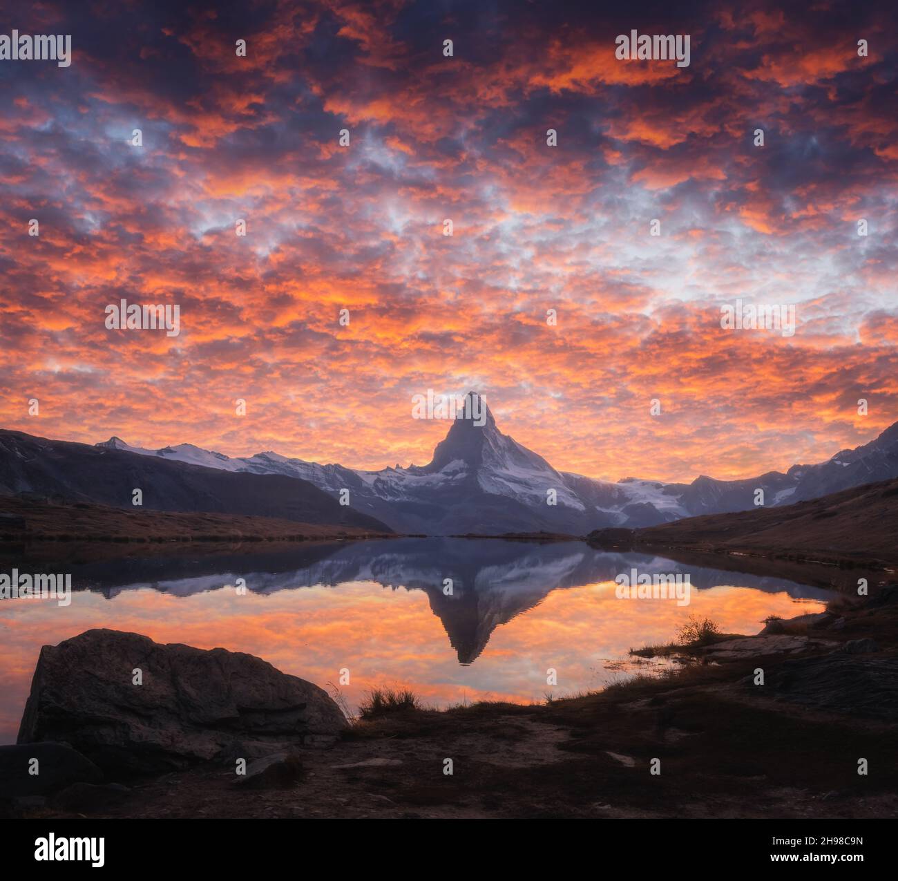 Splendid landscape with colorful sunrise on Stellisee lake. Snowy ...