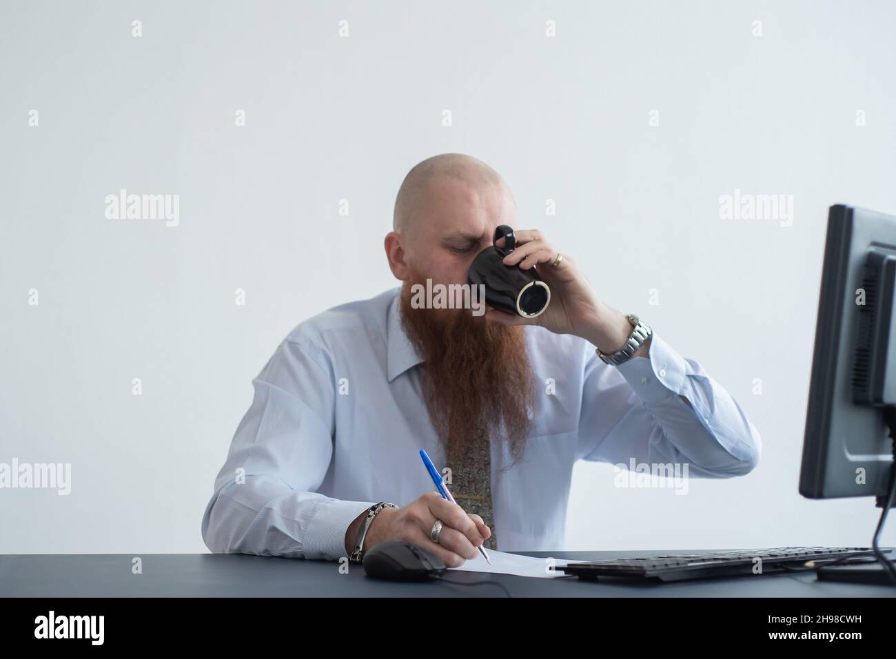 Problems for the office worker. A bald man in a white shirt sits at a ...