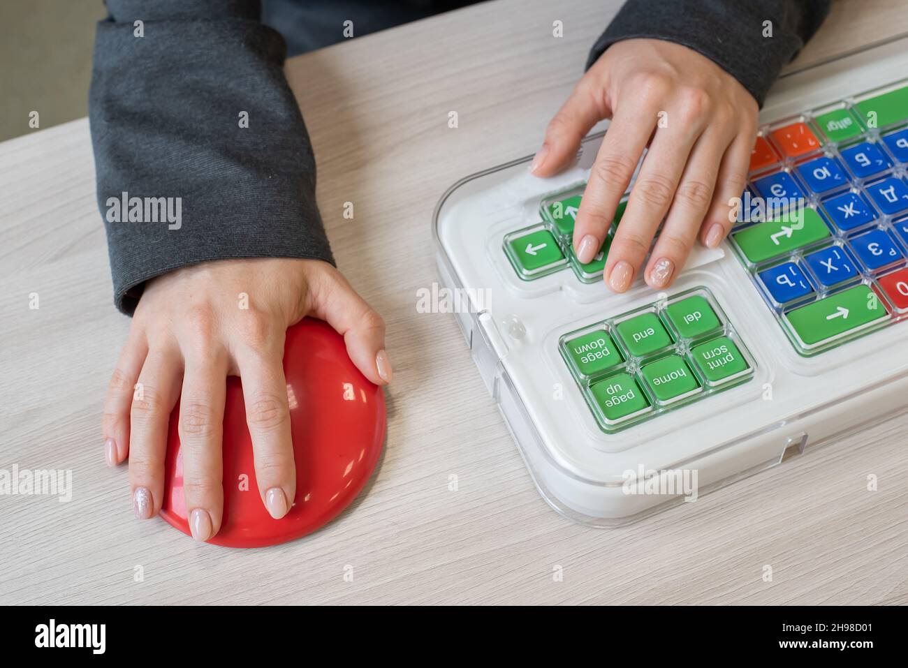 Woman with cerebral palsy working on a specialized wireless computer ...