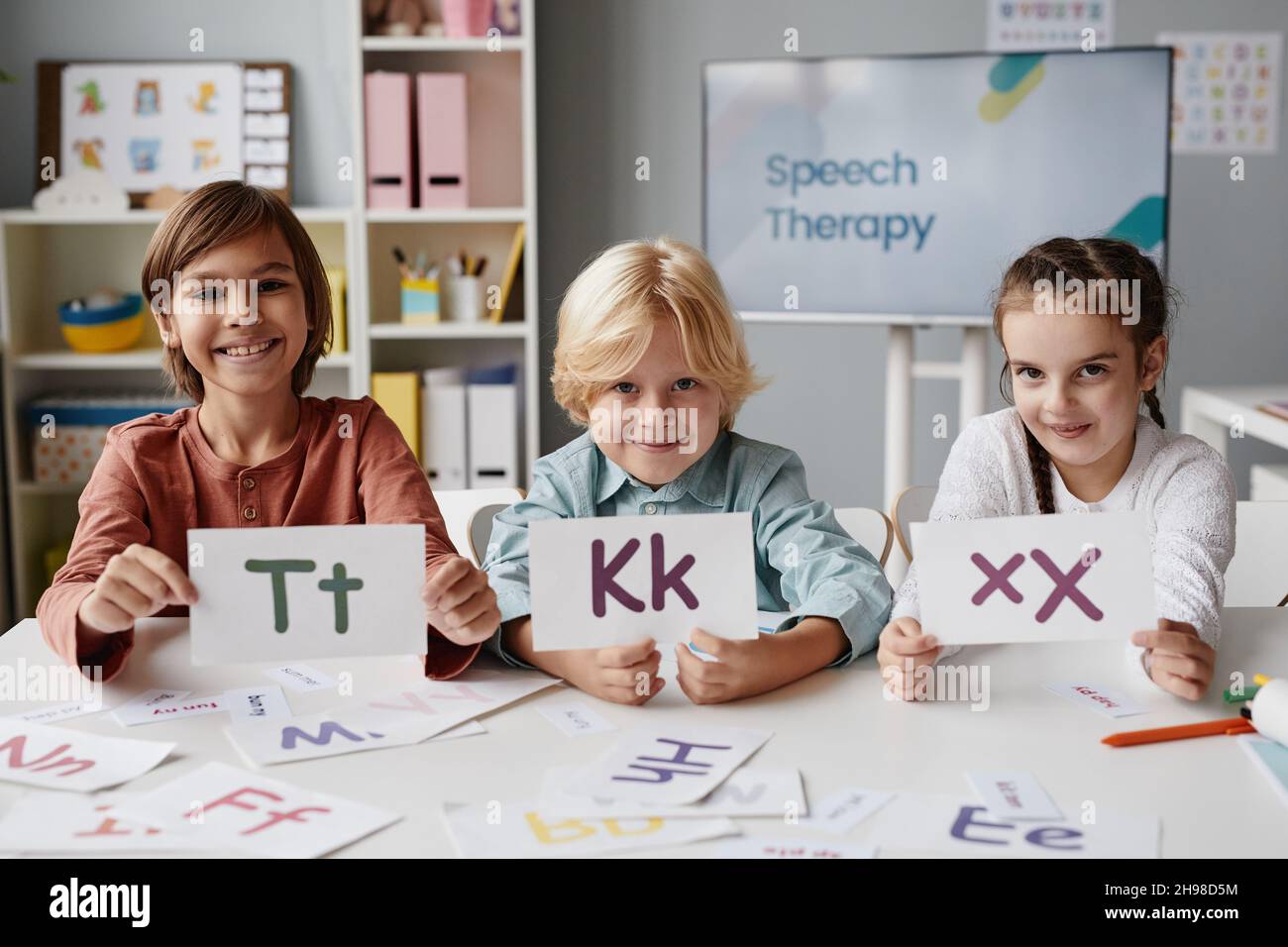 Children holding alphabet letters hi-res stock photography and images ...