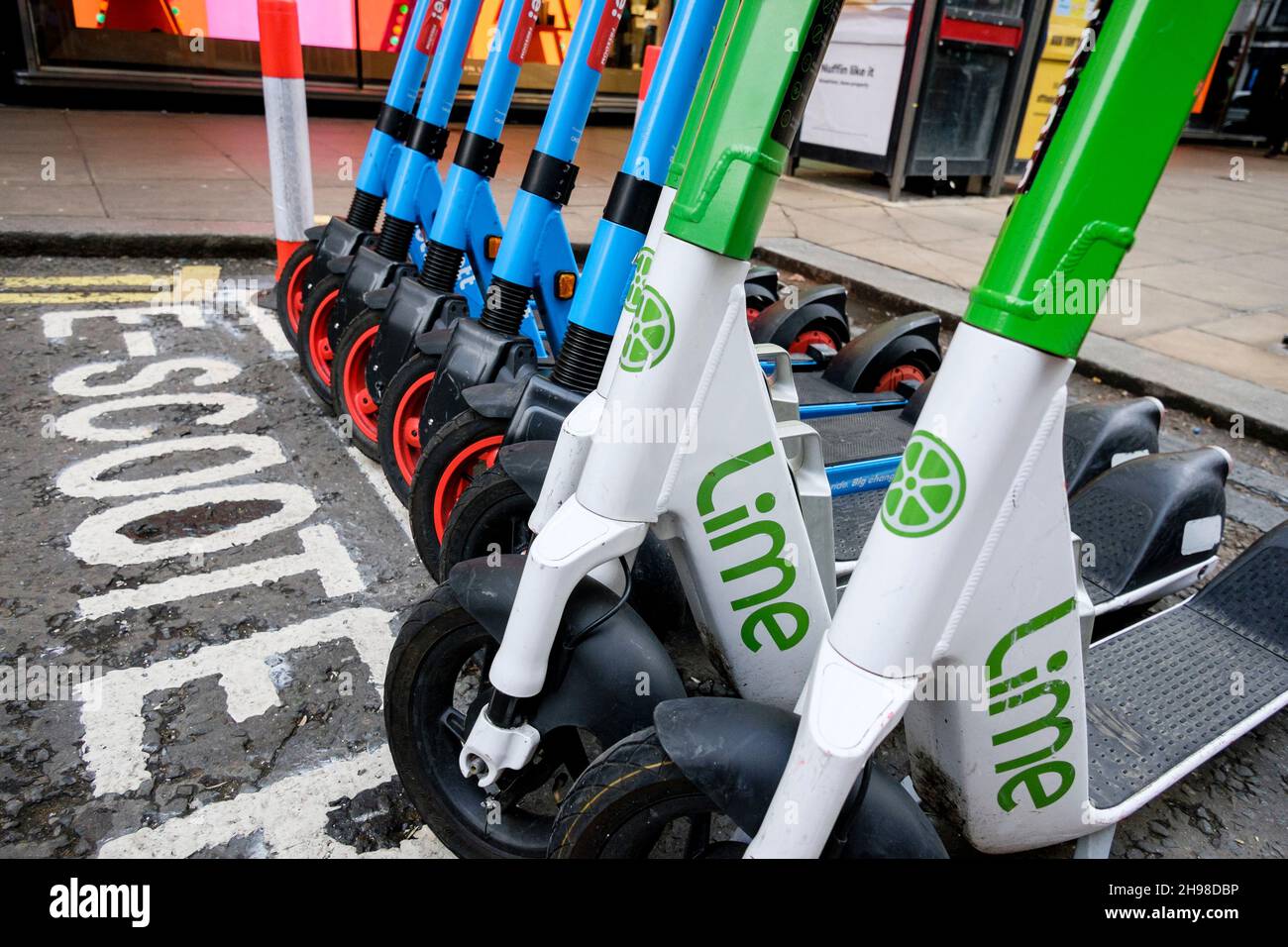 Electric scooters for hire parked in dedicated bay, London, UK Stock ...