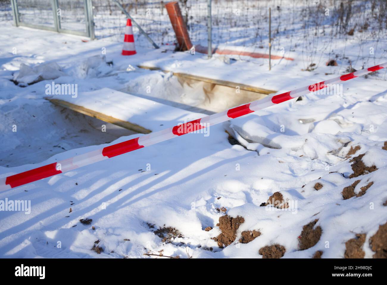 Small construction site on snowy terrain. Barrier tape in focus. Deep ...