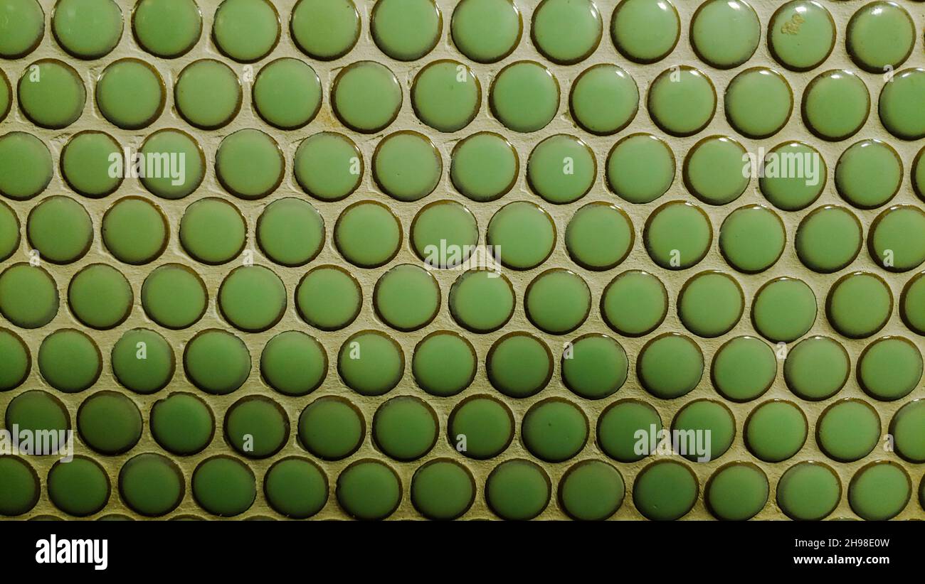 wall with round mosaic tiles in green Stock Photo - Alamy