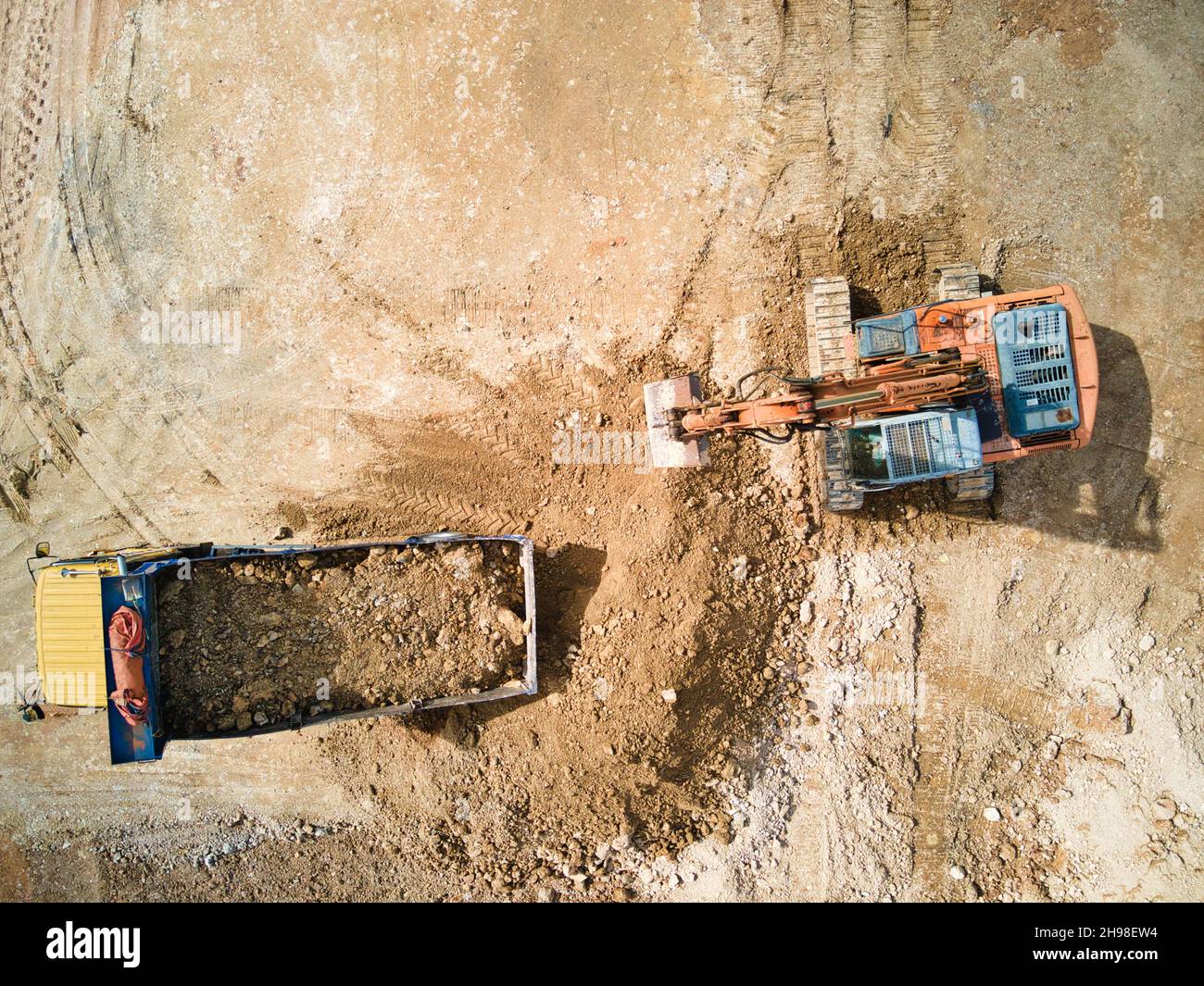 excavator and construction truck at site - top drone view Stock Photo ...