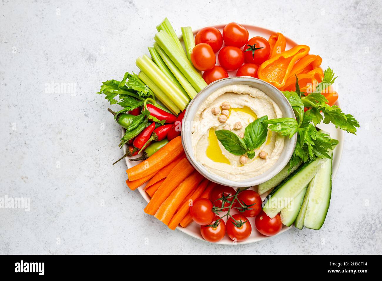 Hummus platter with assorted snacks. Hummus in bowl and vegetables ...
