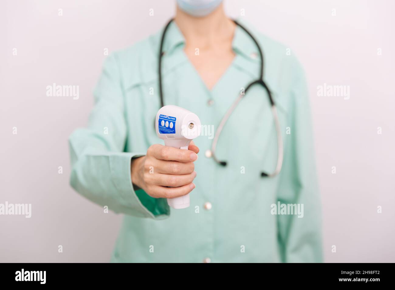 Temperature measurement gun in doctor hands. Close-up shot of doctor ...