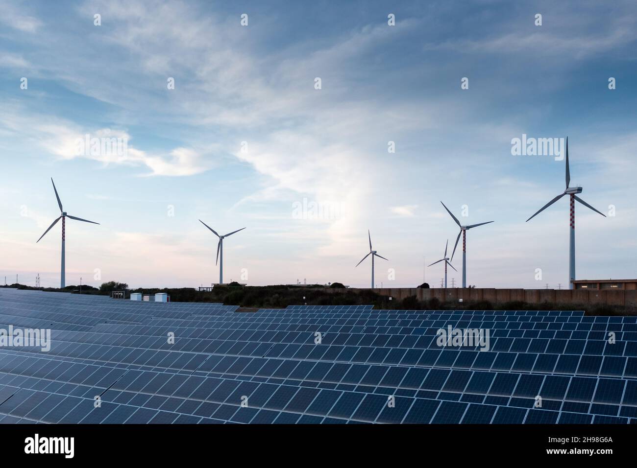 Solar panels and wind turbines producing green energy for clean ...