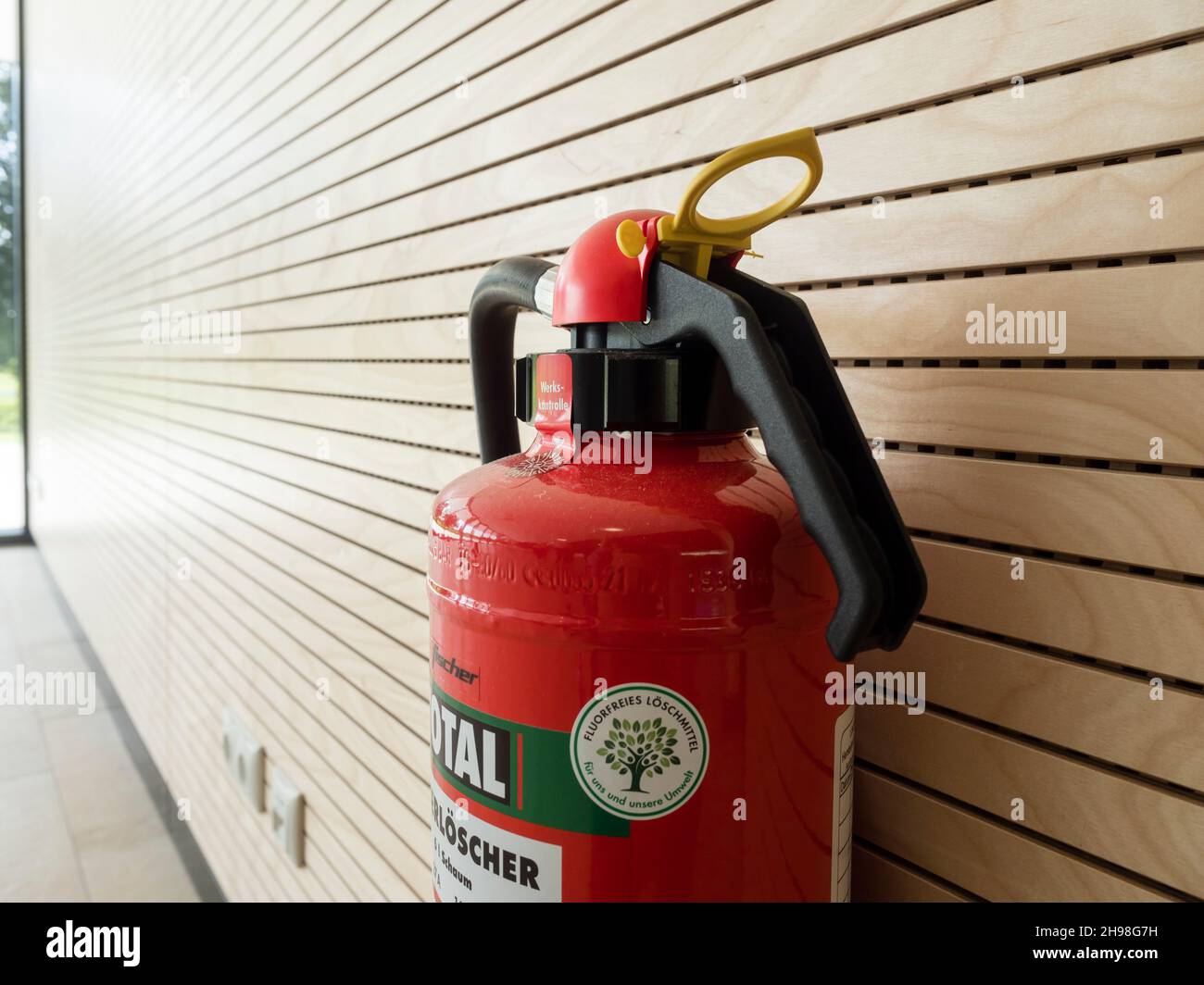 Fire extinguisher on a wall inside a building Stock Photo - Alamy