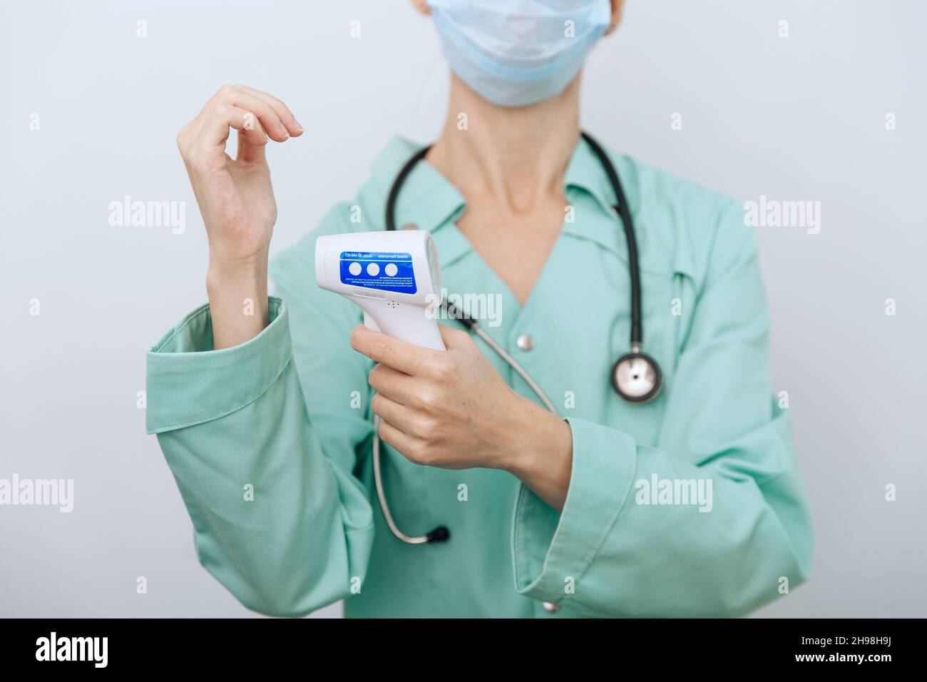 Temperature measurement gun in doctor hands. Close-up shot of doctor ...