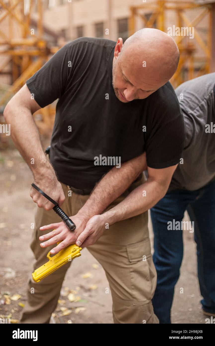 Kapap instructor demonstrates self defense techniques against a gun ...
