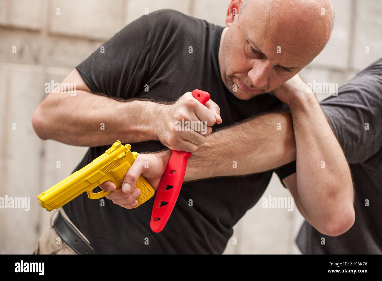 Kapap instructor demonstrates self defense techniques against a gun ...