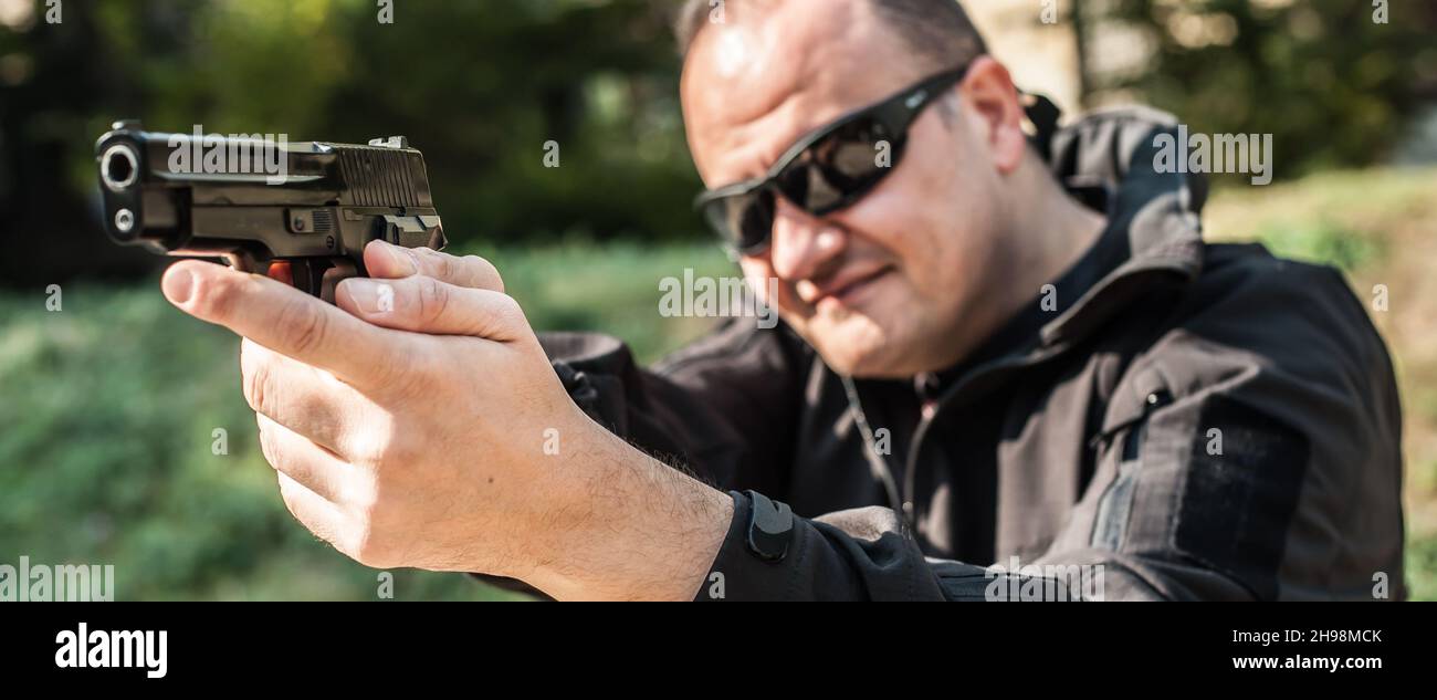 Police agent and bodyguard pointing pistol to protect from attacker ...