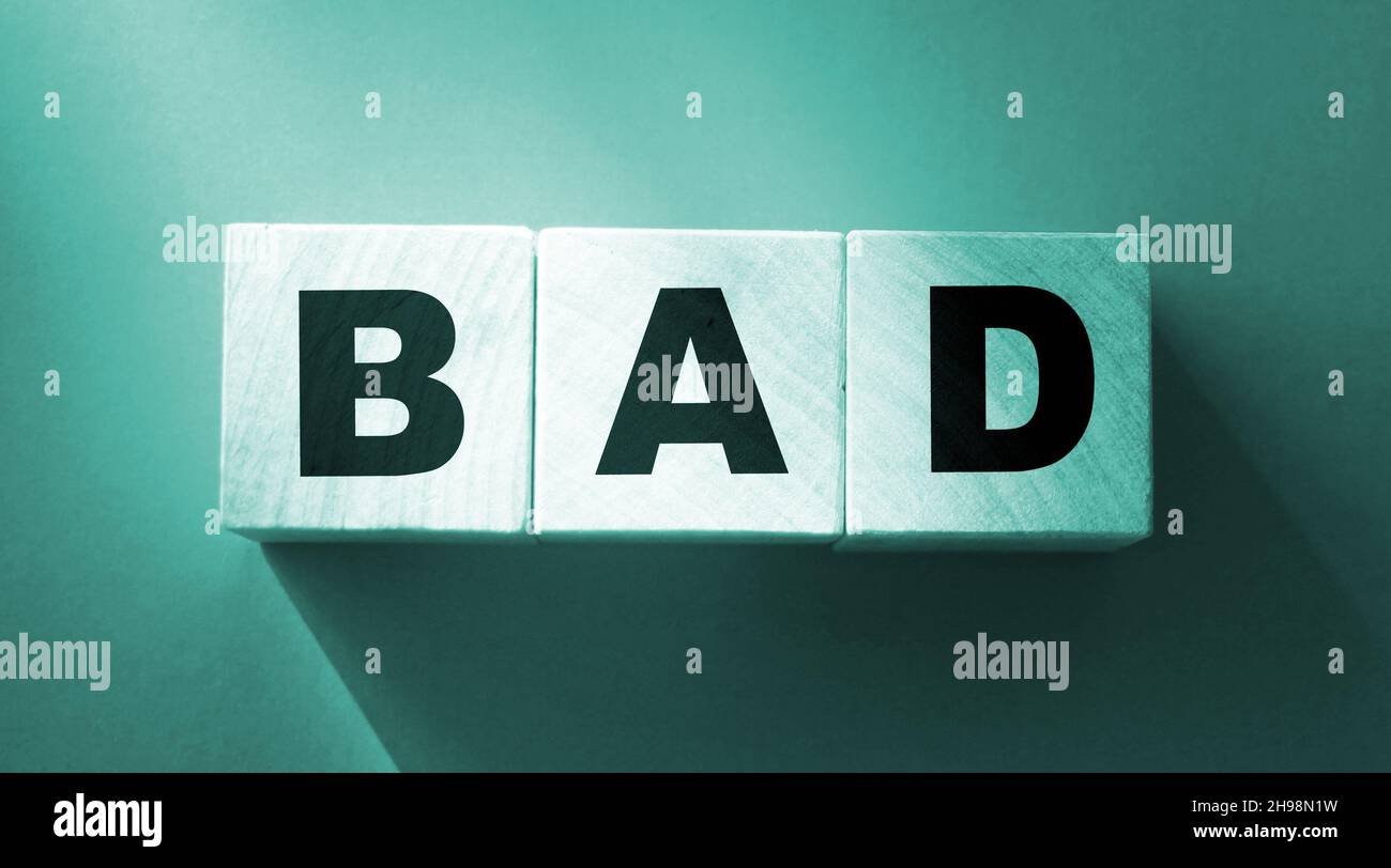 Bad word on wooden blocks on red background. Something negative concept ...