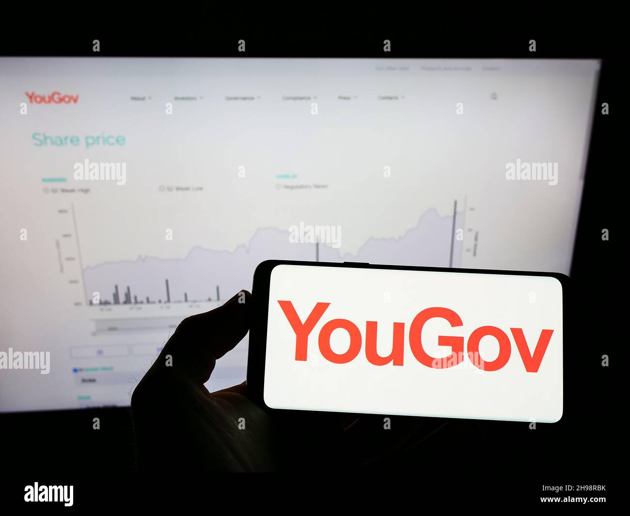 Person holding mobile phone with logo of British market research ...