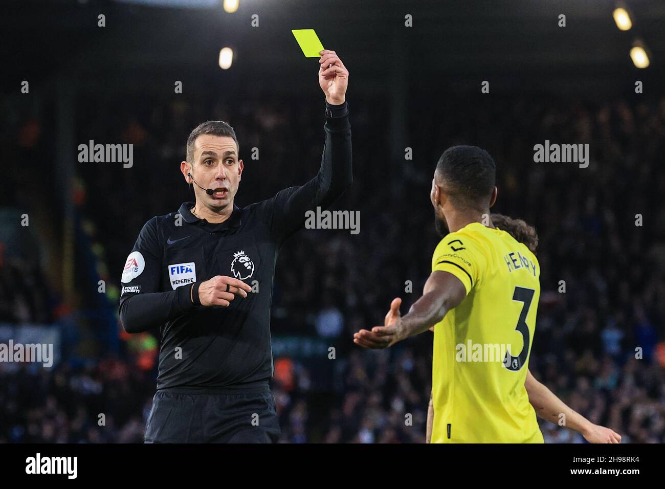 Referee David Coote gives Rico Henry #3 of Brentford a yellow card ...
