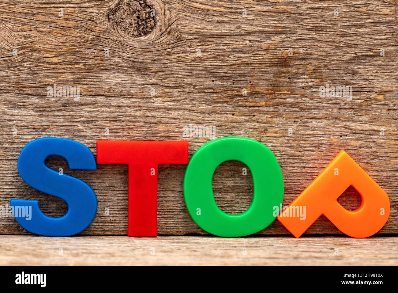 Word STOP made of color plastic letters Stock Photo - Alamy