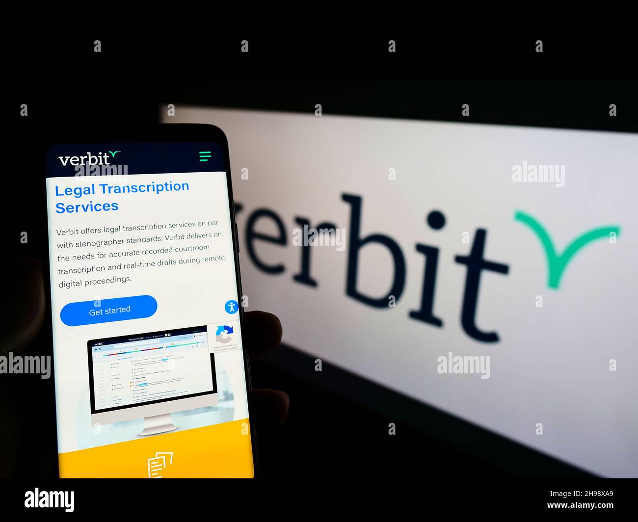 Person holding cellphone with webpage of automated transcription ...