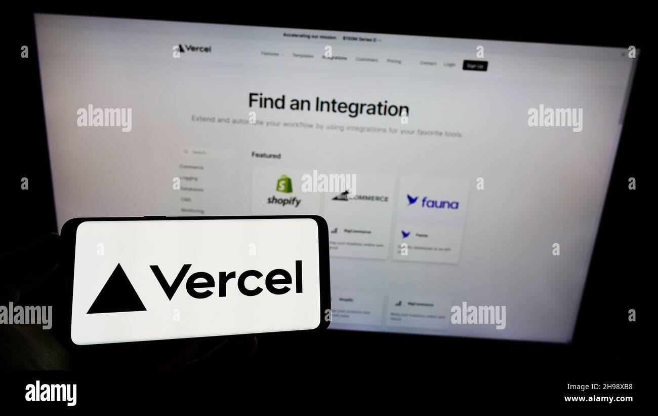 Person holding mobile phone with logo of American software development ...
