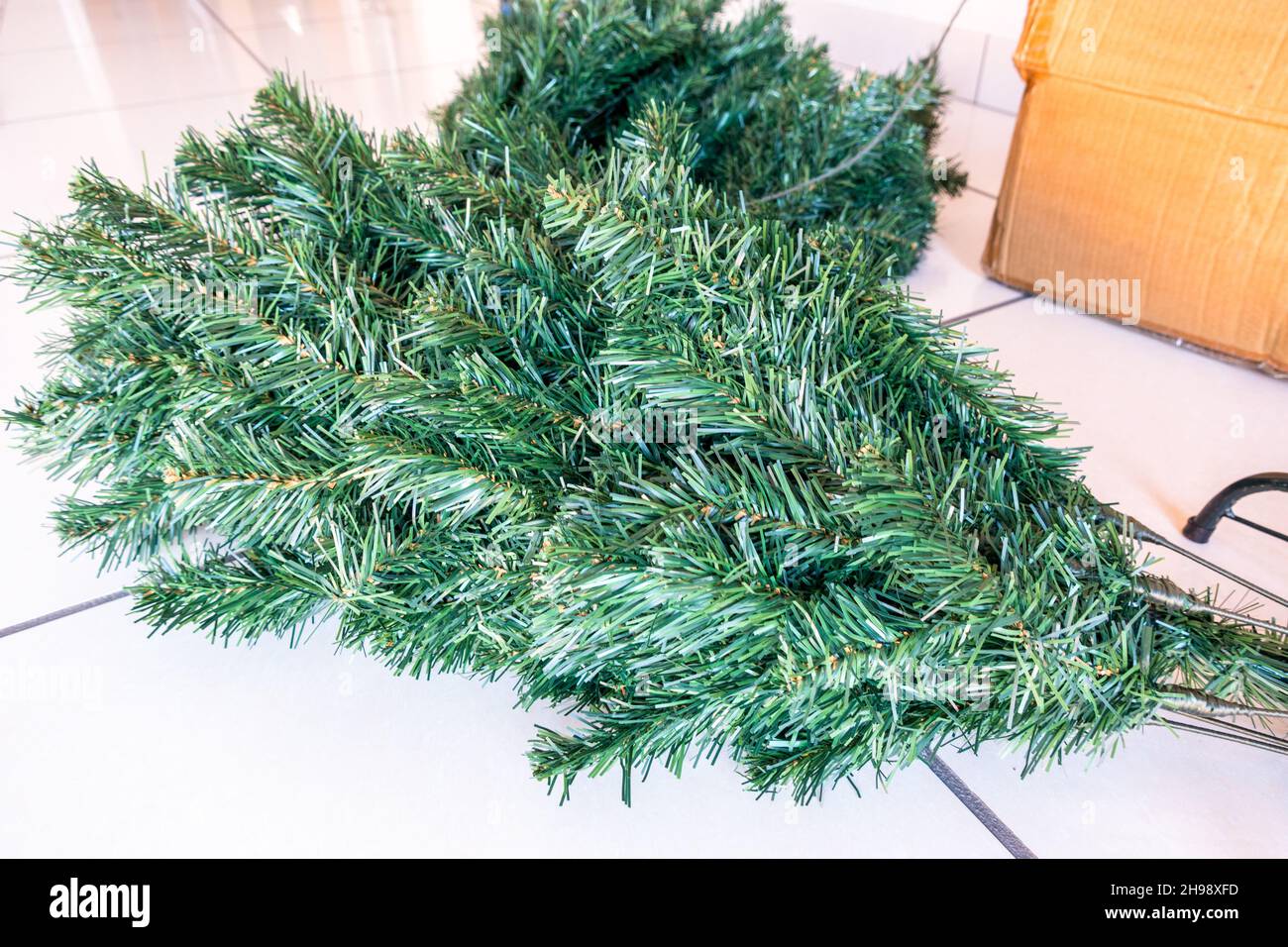 Christmas tree made of plastic out of the cardboard box for set-up ...