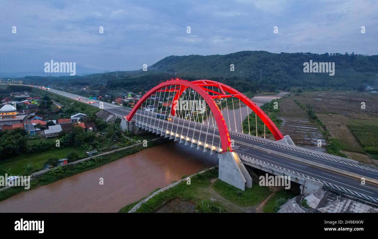 Aerial view of the Kalikuto Bridge, an Iconic Red Bridge at Trans Java Toll Road, Batang when ...