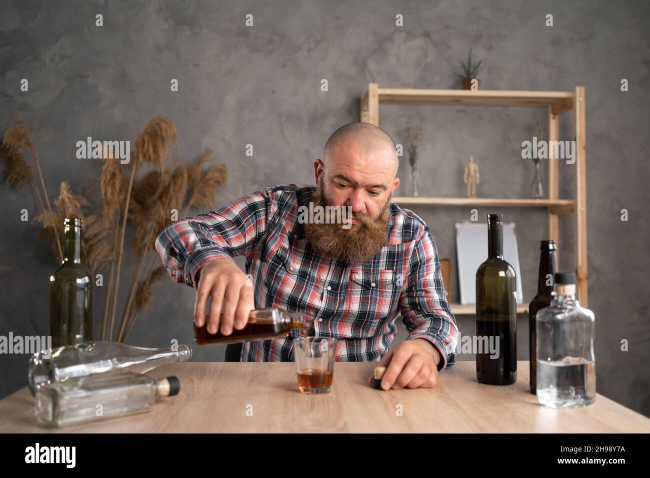 bearded millennial alcoholic man drinking whiskey at home. Alcohol ...