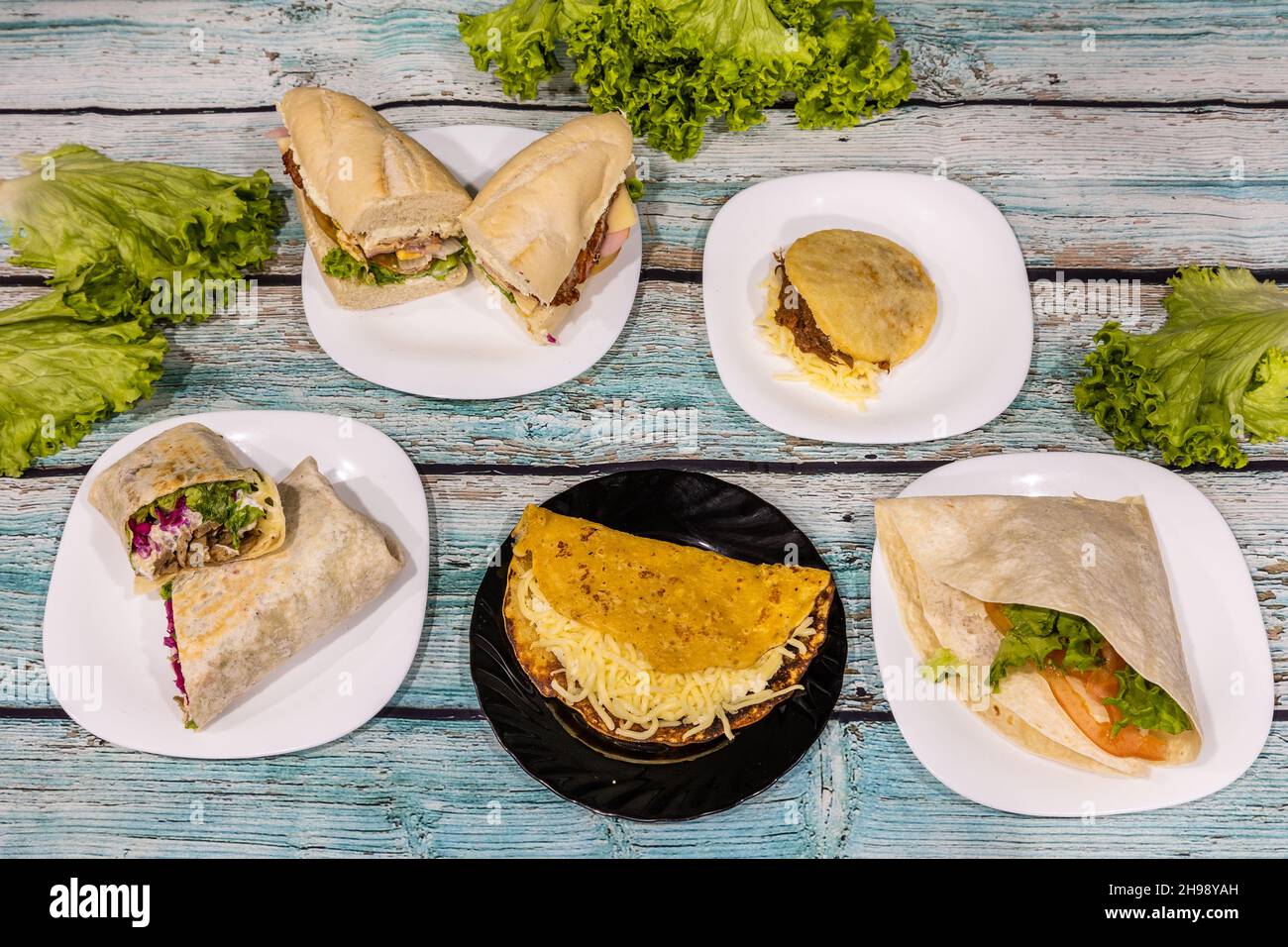A top view of various types of sandwiches and wraps on plates Stock ...