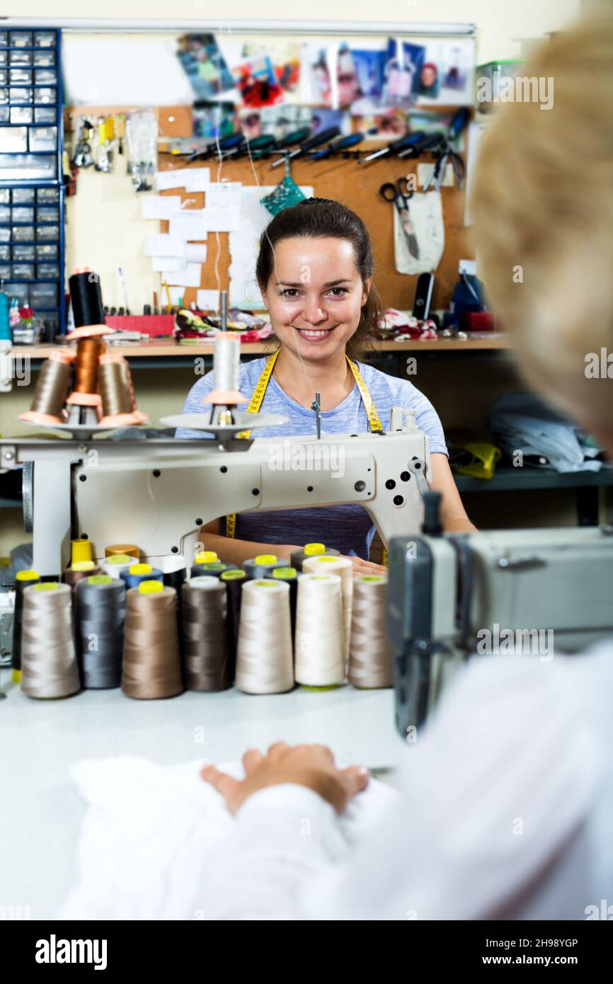 Two women sewing with professional equipment Stock Photo - Alamy