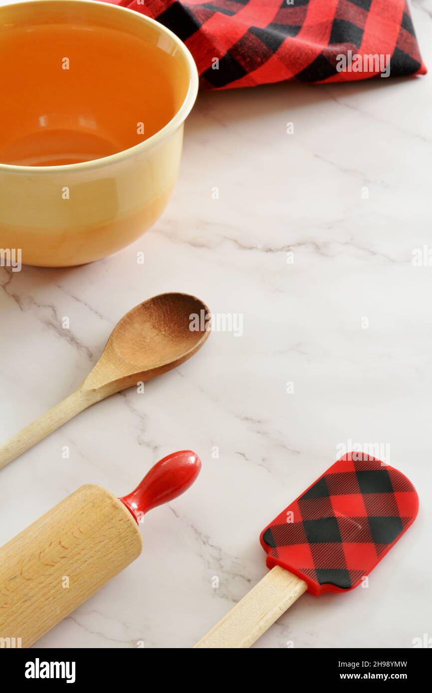 Assorted baking tools on marble background in vertical format with room ...