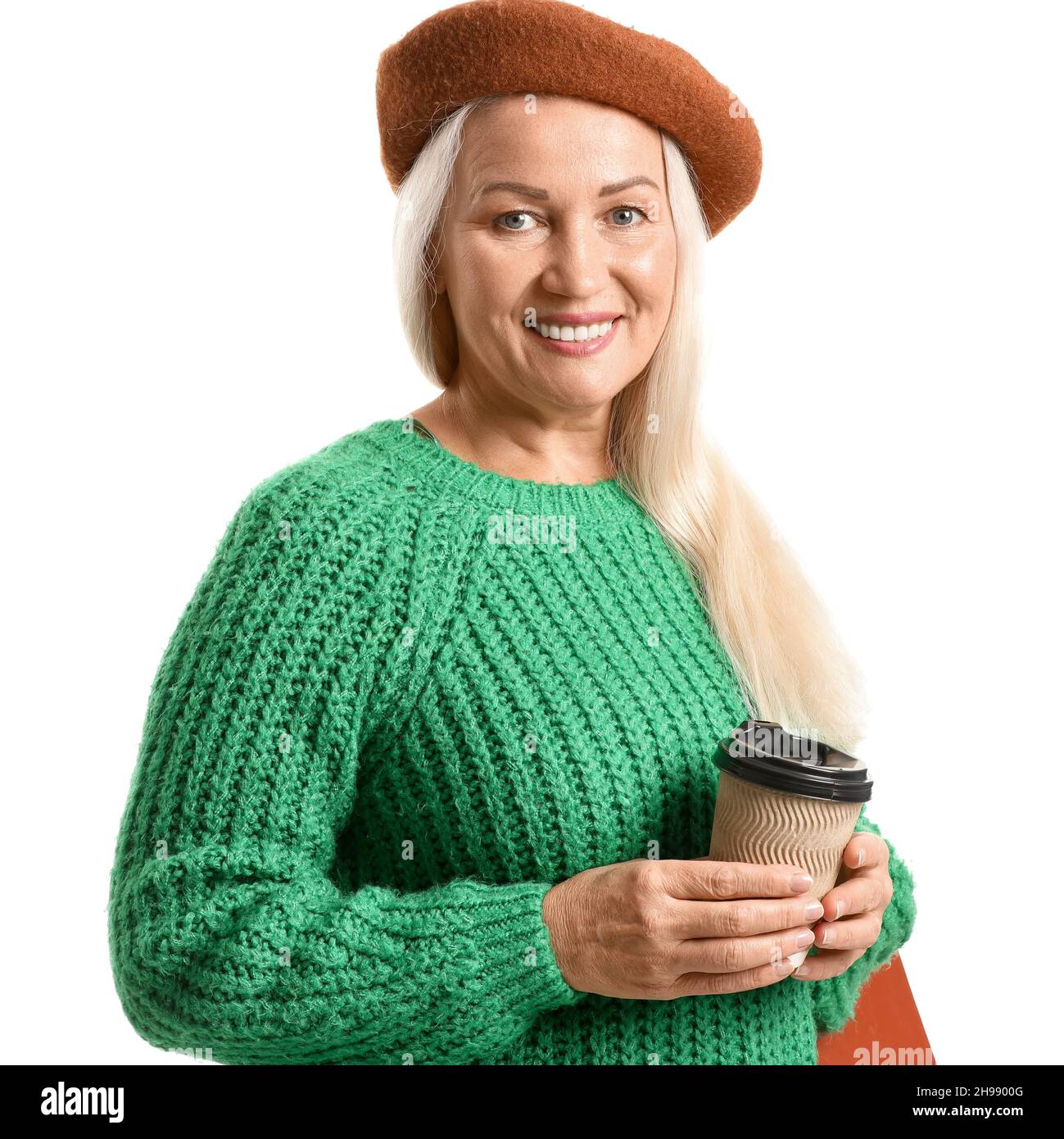 Smiling mature woman in beret hat holding paper cup with drink on white ...