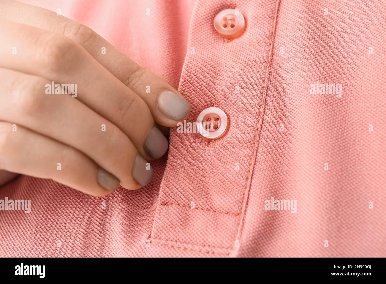 Woman buttoning shirt hi-res stock photography and images - Alamy