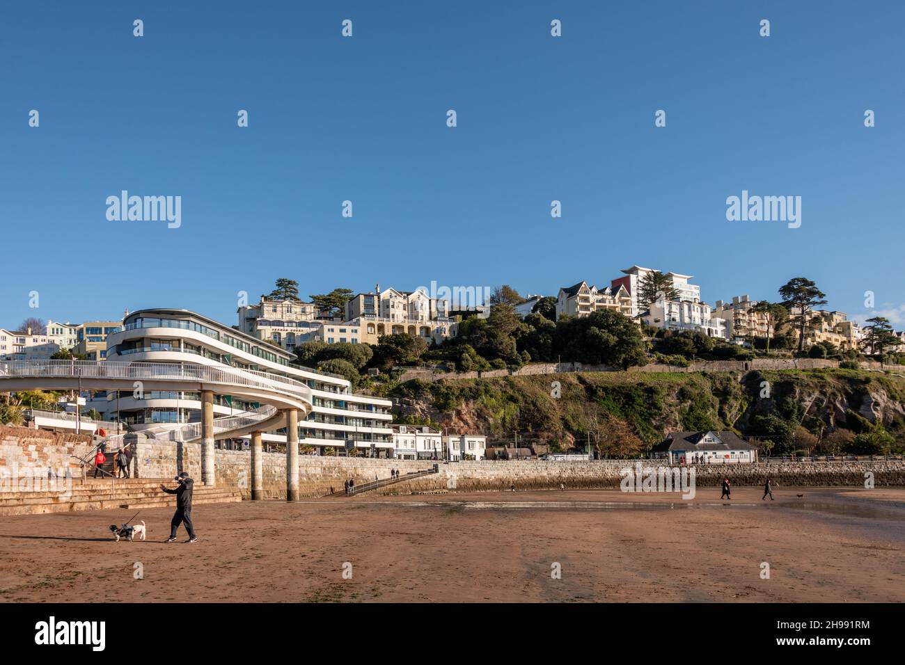 Torquay, UK. People walking on the beach at Torquay and Paington with ...
