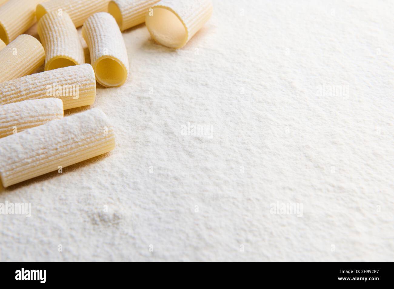 Whole wheat Italian pasta - raw tortiglioni- in the corner of a white ...