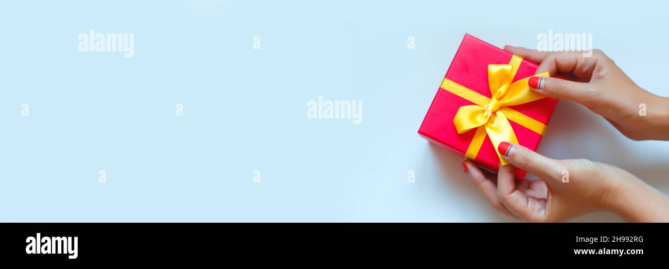 hands hold a gift on a white background Stock Photo - Alamy