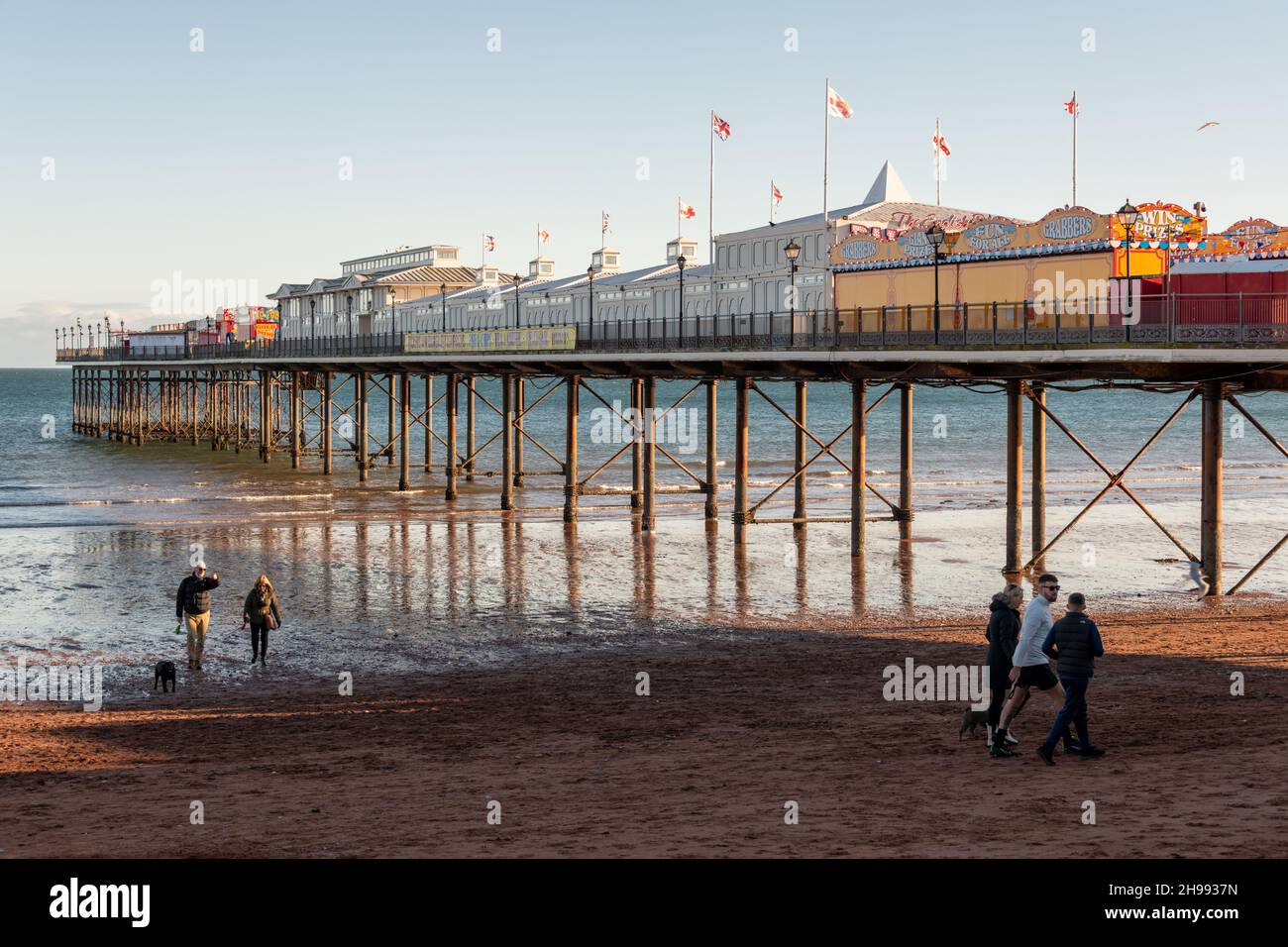Torquay, UK. People walking on the beach at Torquay and Paington with ...