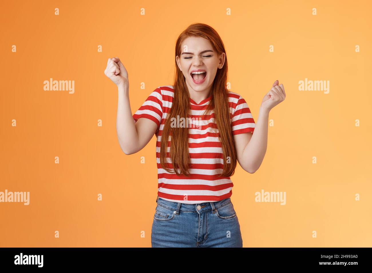 Luck cute redhead girl, make fist pump cheerfully yell yes, close eyes ...