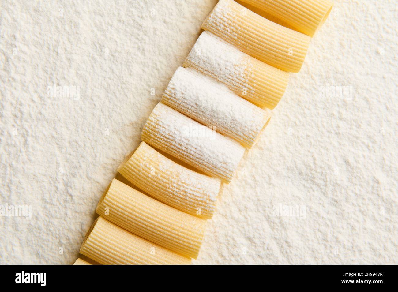 Flat lay composition of neatly arranged whole wheat Italian pasta in a ...
