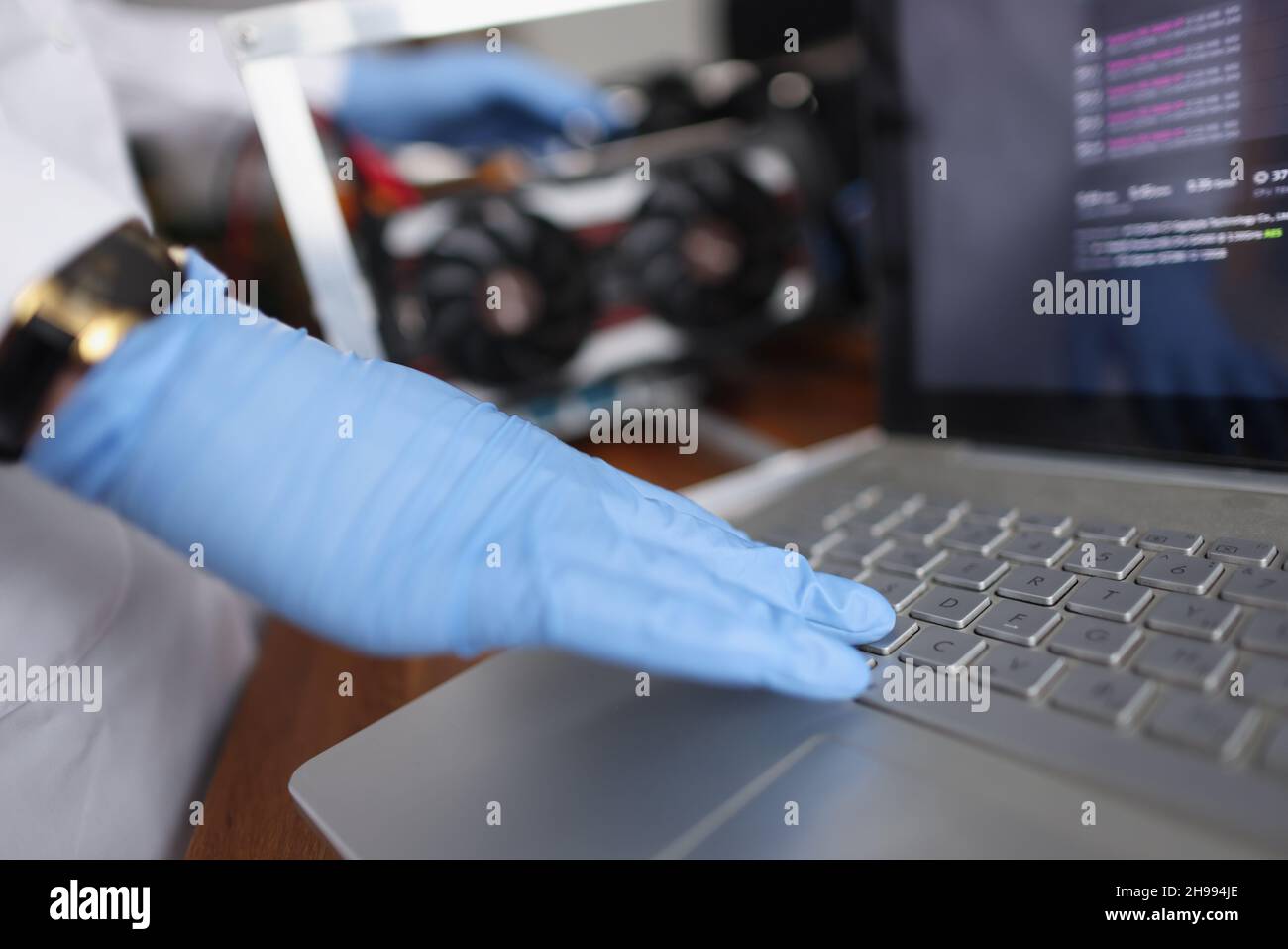Professional technician man touching laptop keyboard wearing sterile ...