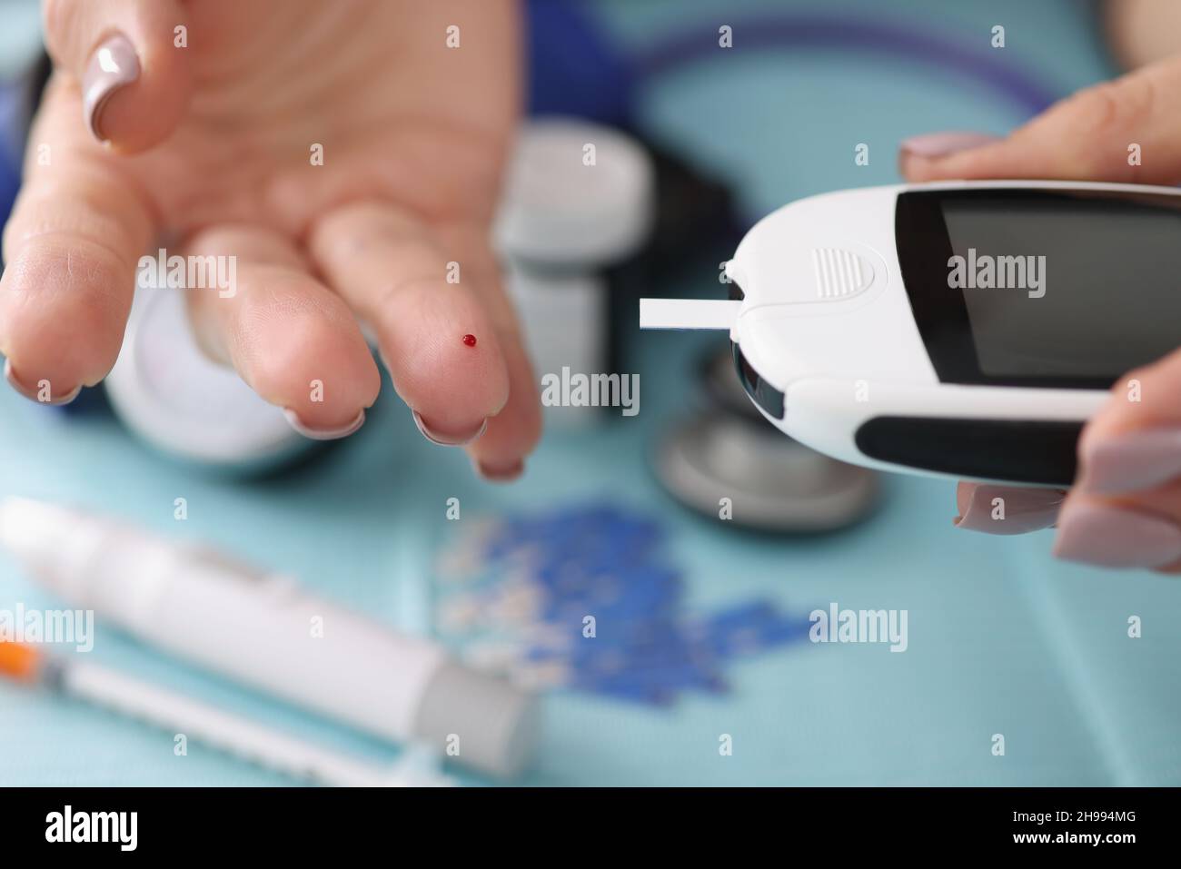 Doctor check blood sugar level of client use digital glucometer at ...