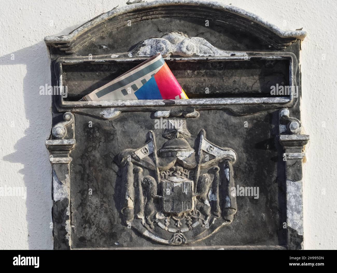 Metal old mail box with a newspaper Stock Photo - Alamy