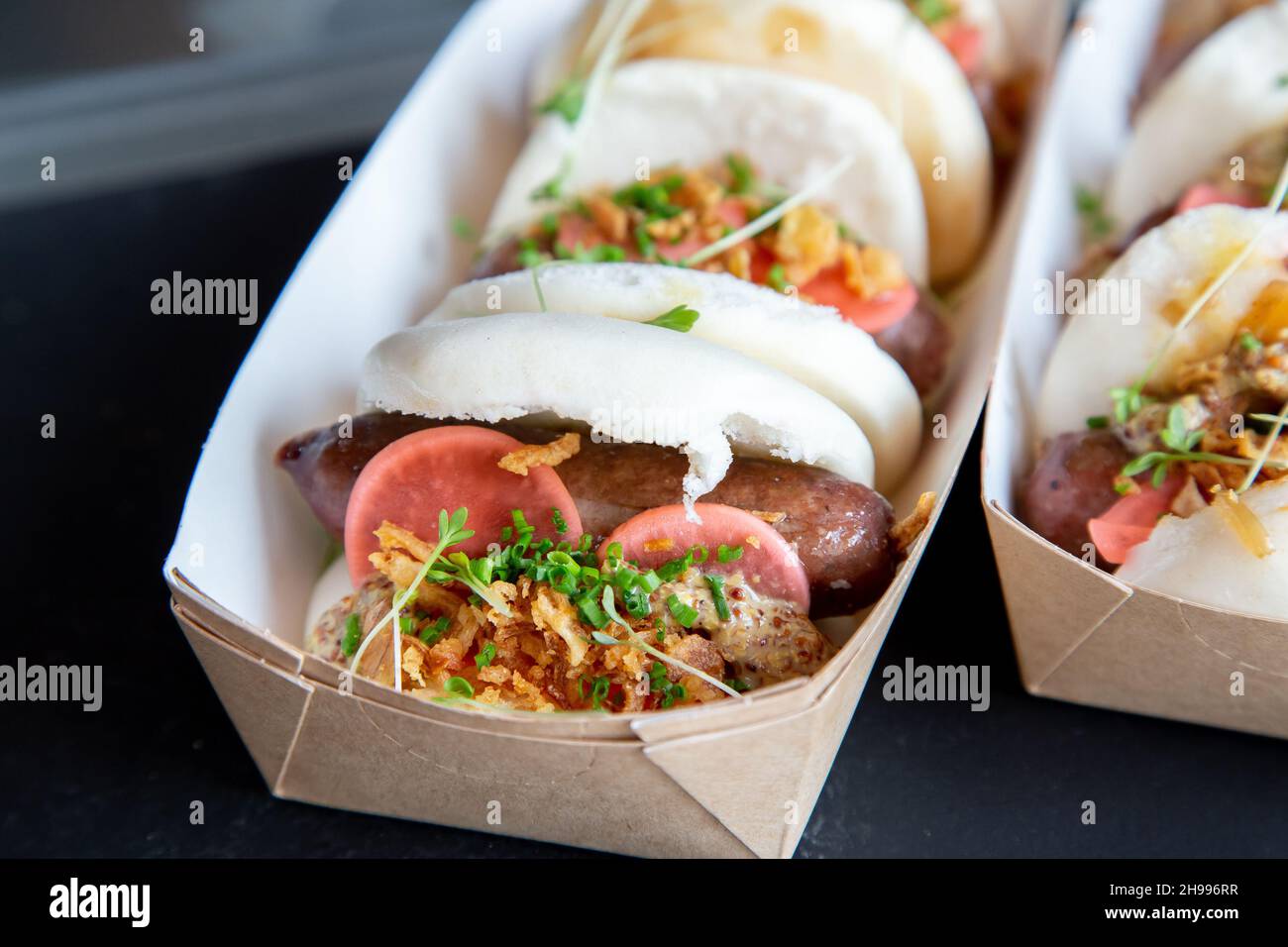 A close-up shot of mini hot dogs in a small carton box Stock Photo - Alamy