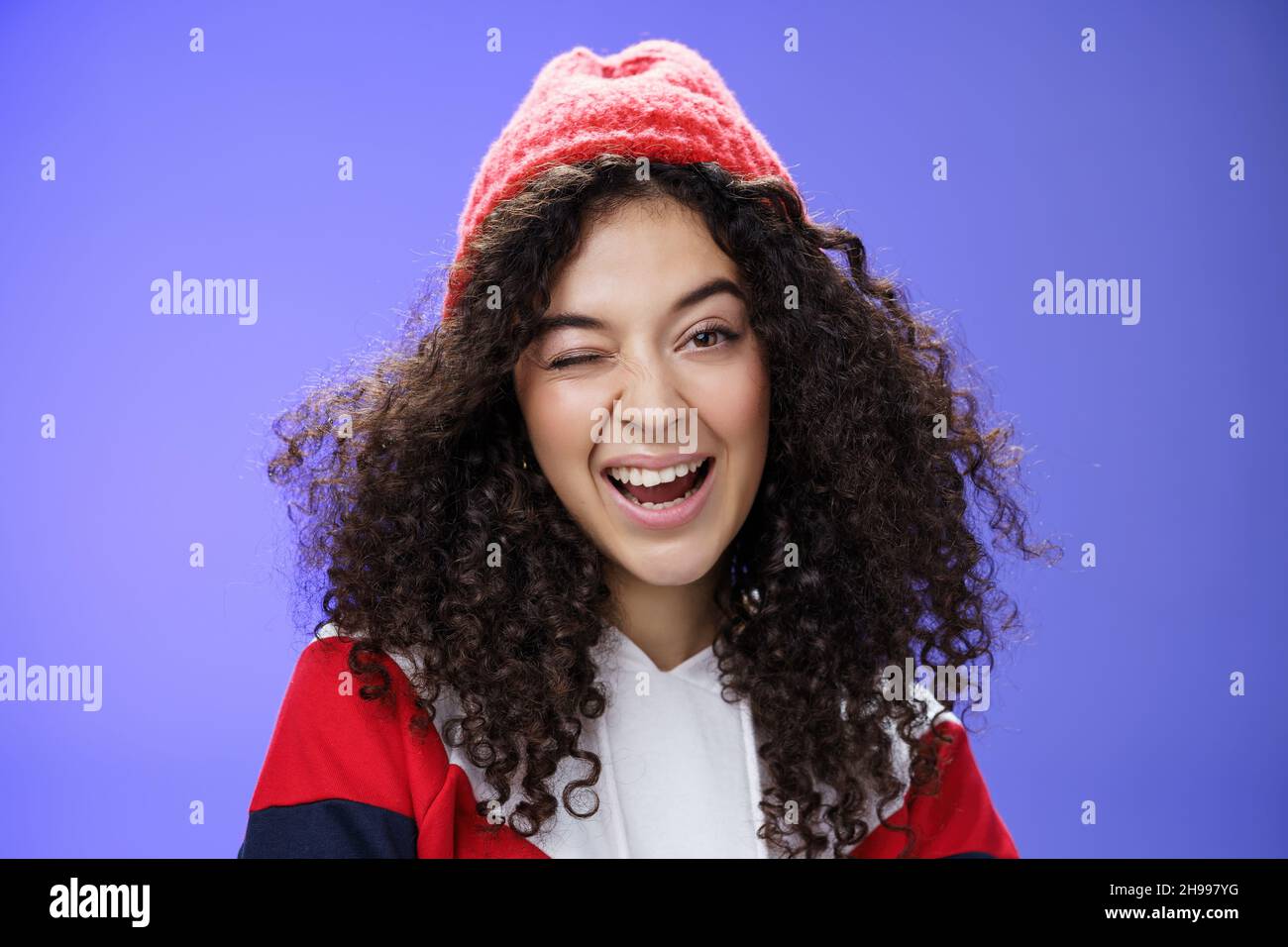 Charming cute woman hinting to go play snowballs with her winking ...