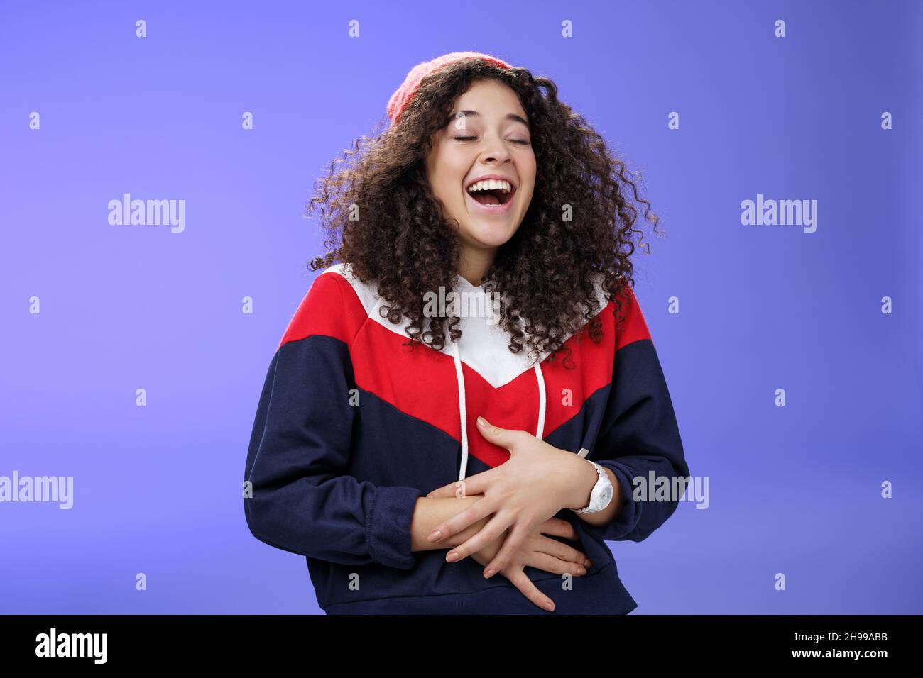 Girl hearing hilarious funny joke, making prank over friend laughing ...