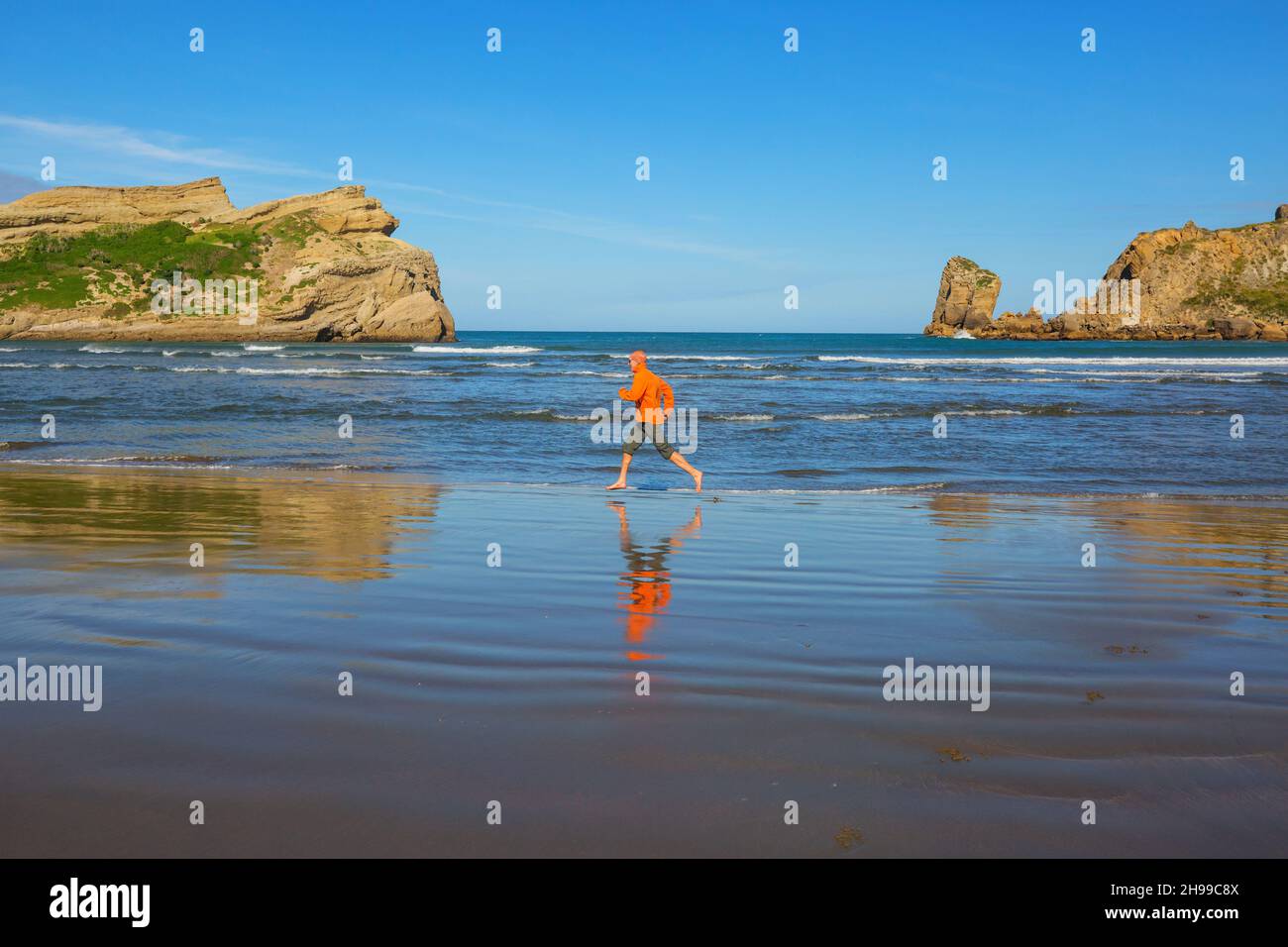Running man in ocean coast Stock Photo - Alamy
