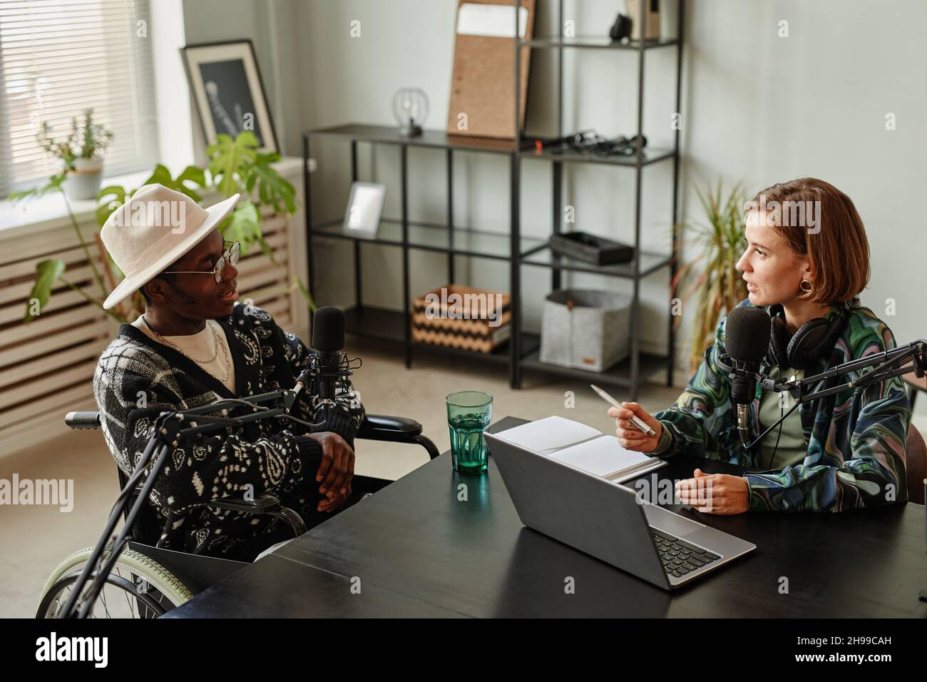 High angle portrait of African-American person in wheelchair giving ...