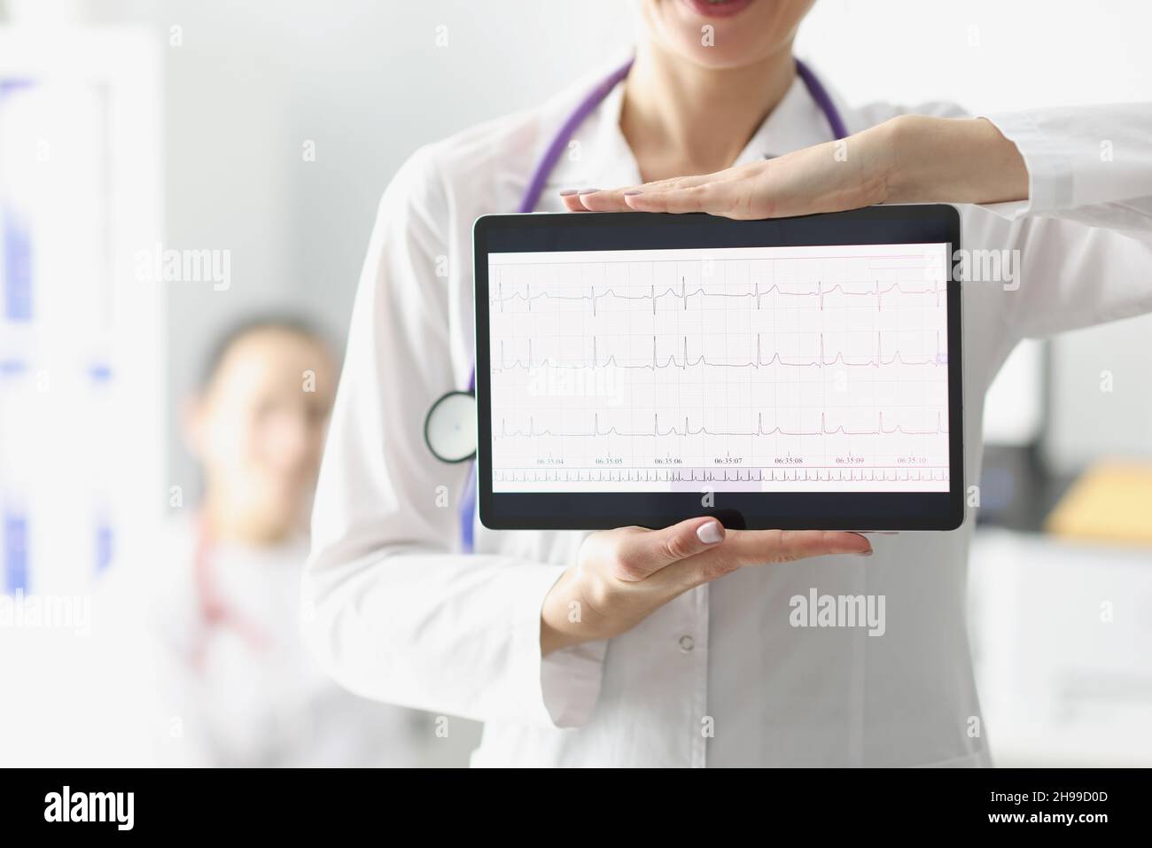 Doctor showing digital tablet screen with heart cardiogram result Stock ...