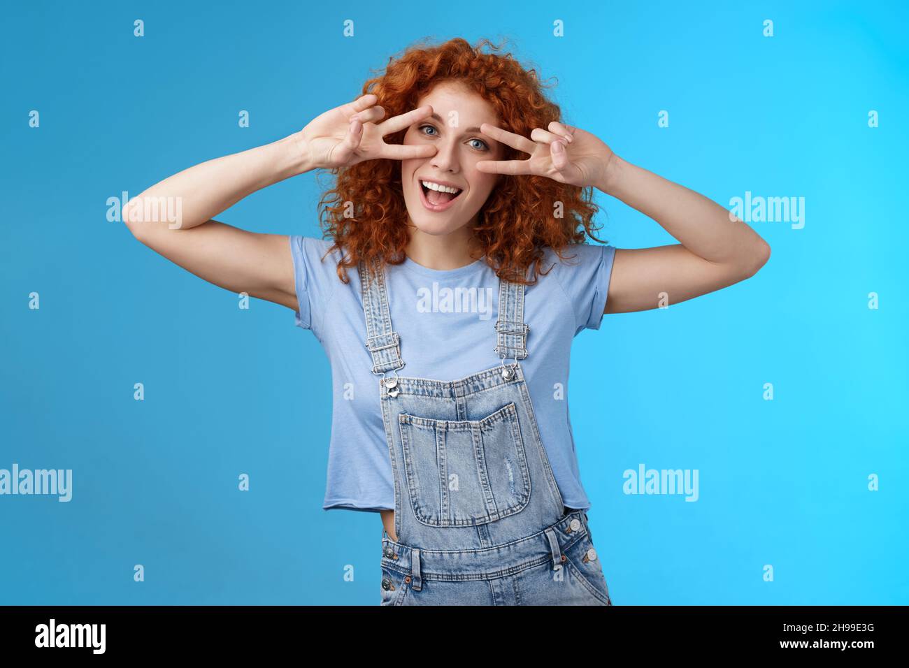 Cheerful cute redhead ginger girl curly haircut show positivity peace ...