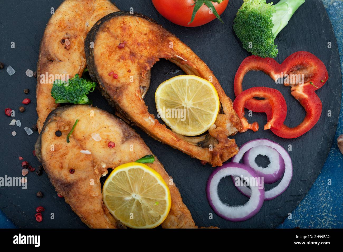 Christmas carp, Fried carp fish slices on a black plate. Fried golden ...