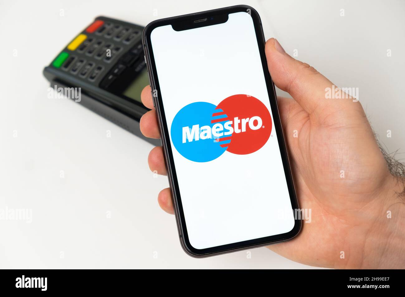 Maestro debit electronic payment system. A man pays for goods and ...